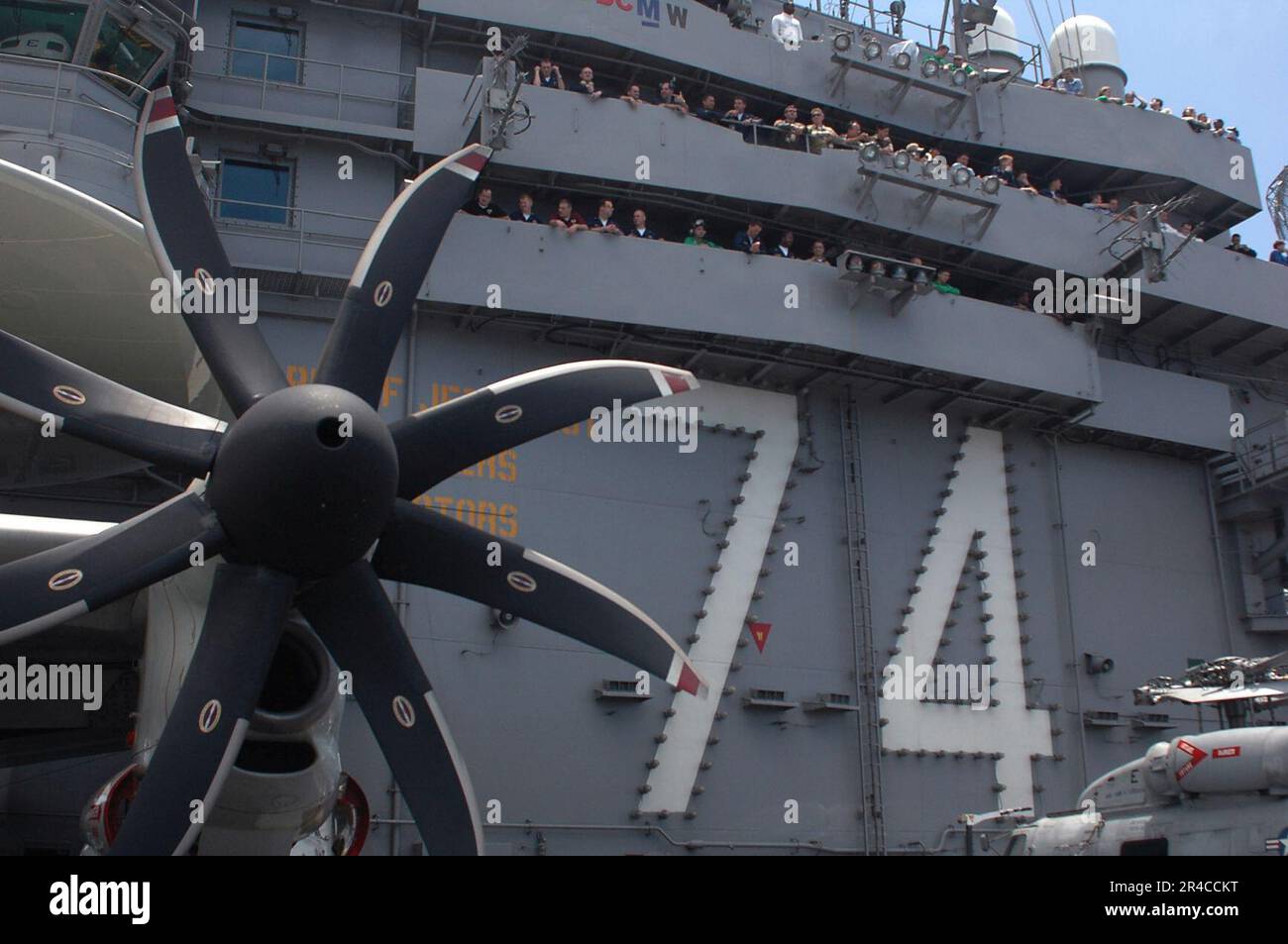 US Navy Sailors gather on the island structure of the Nimitz-Class ...