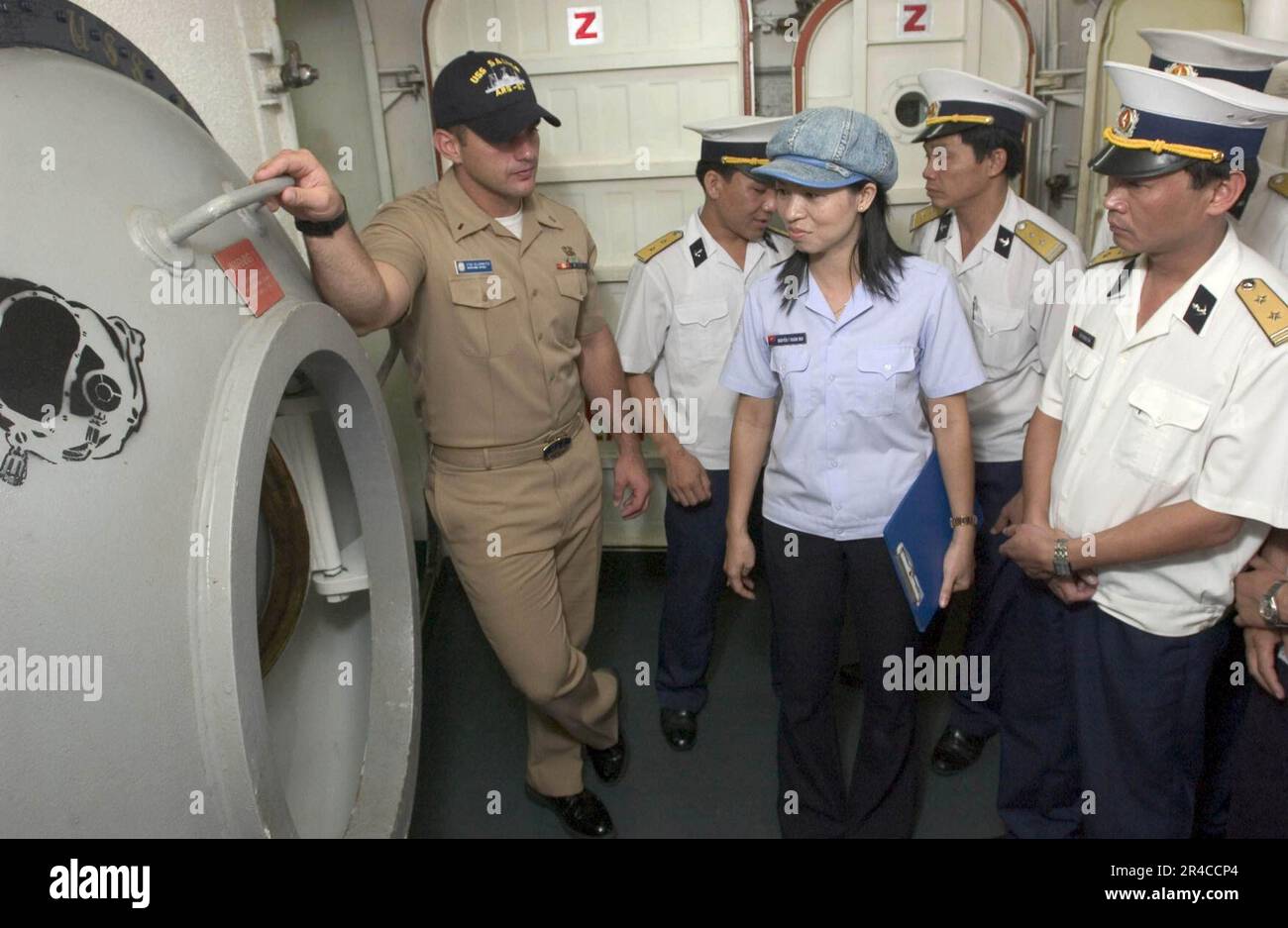 US Navy Lt.j.g. explains to visitors from the Navy division of the ...