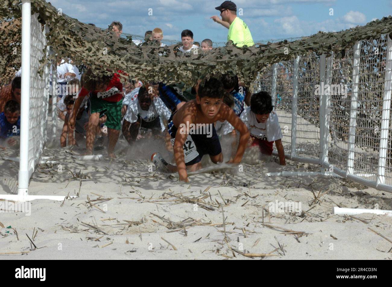 US Navy Children aged 9-12 take part in the first obstacle of the Mini ...