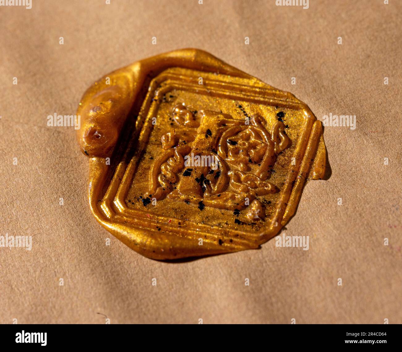 An image of a gold wax seal affixed to a paper bag, isolated on a white ...