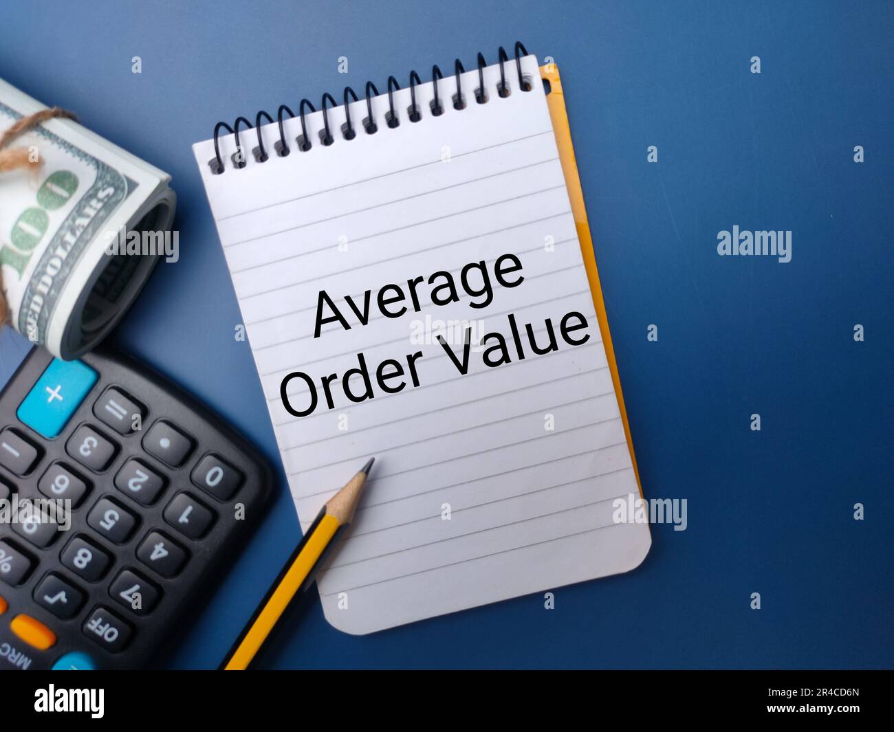 An image of a black notebook with a calculator placed on top and the ...