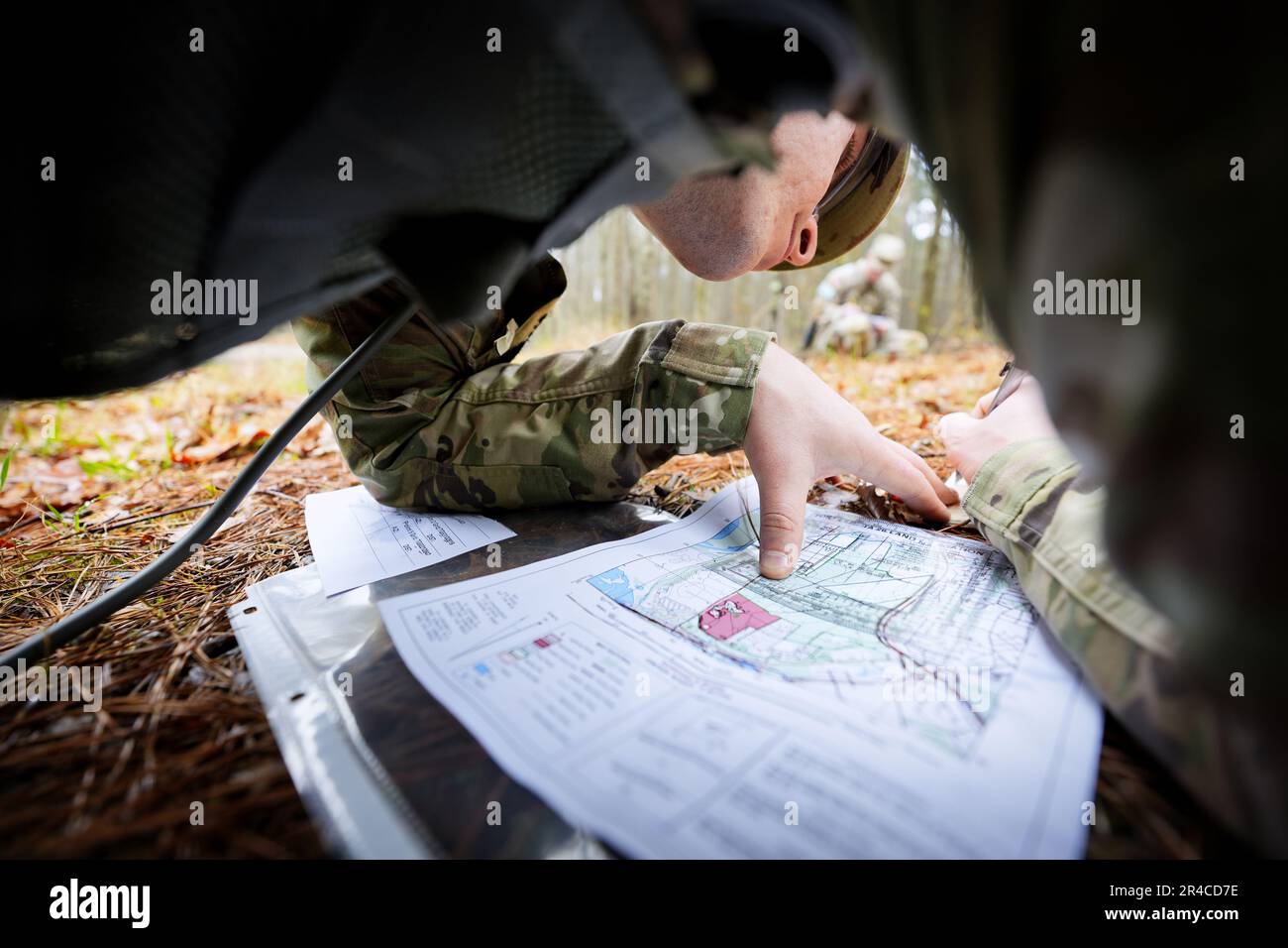 A Soldier plots coordinates in preparation to complete the land ...