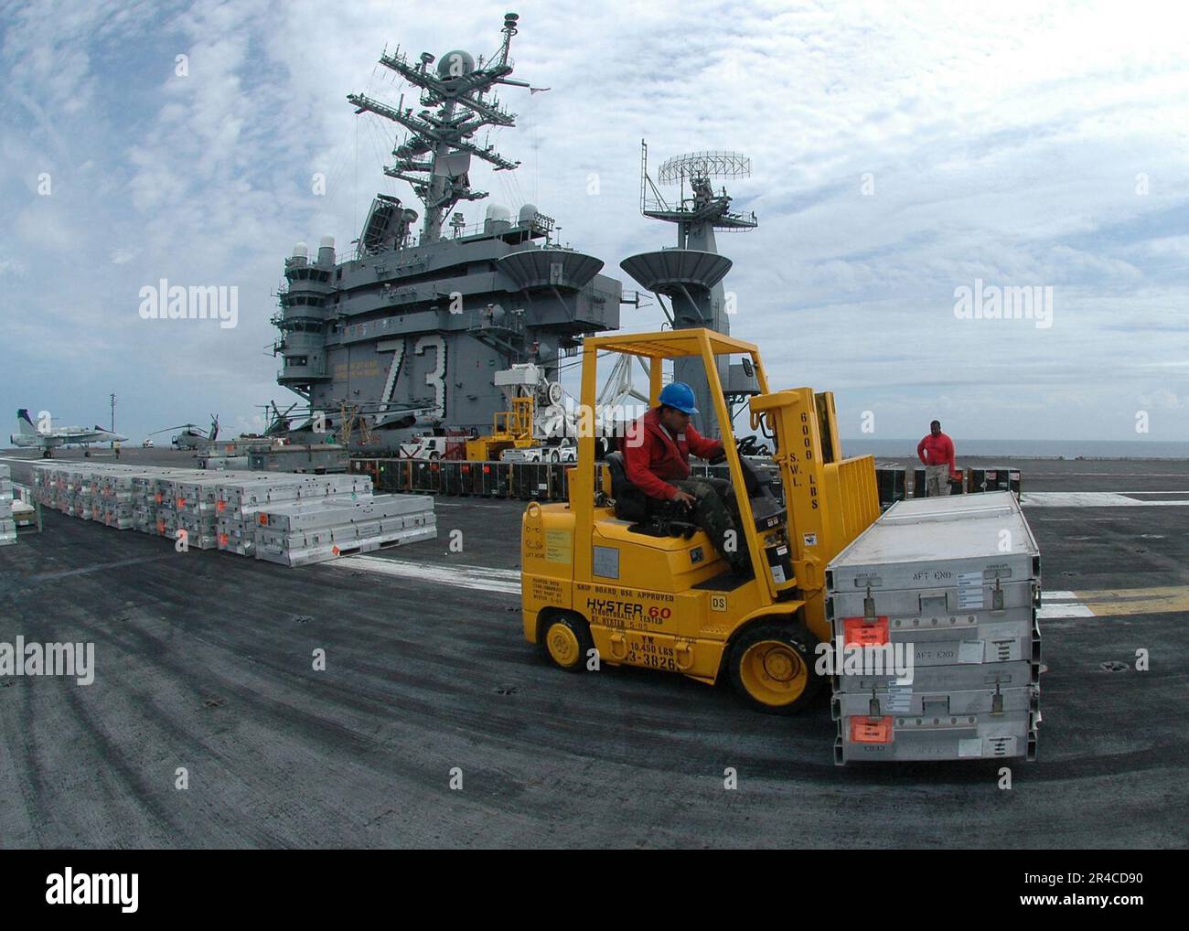 US Navy Aviation Ordnanceman Airman transports ammunition on the flight ...