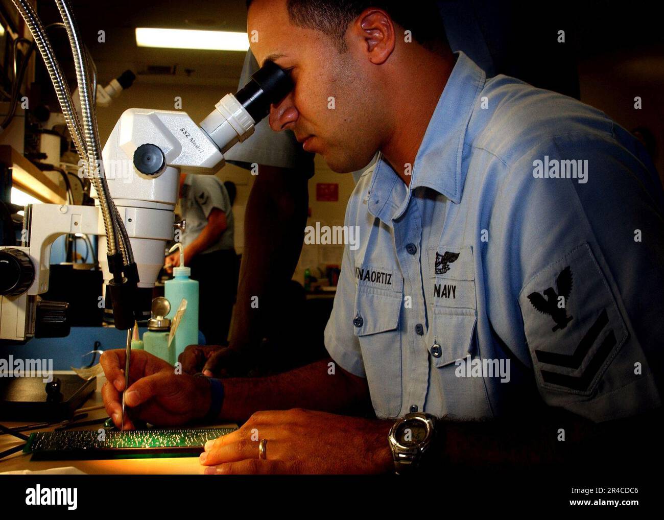 US Navy Aviation Electronics Technician 2nd Class inspects a circuit ...