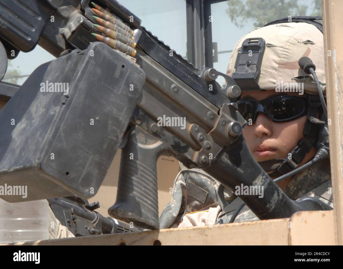 US Navy Airman mans the gun turret of a humvee while maintaining ...