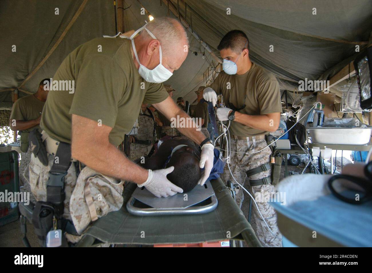 US Navy U.S. Navy Cmdr. Dr. left, examines a patient with a mock head ... US Navy U.S. Navy Cmdr. Dr. left, examines a patient with a mock head ...