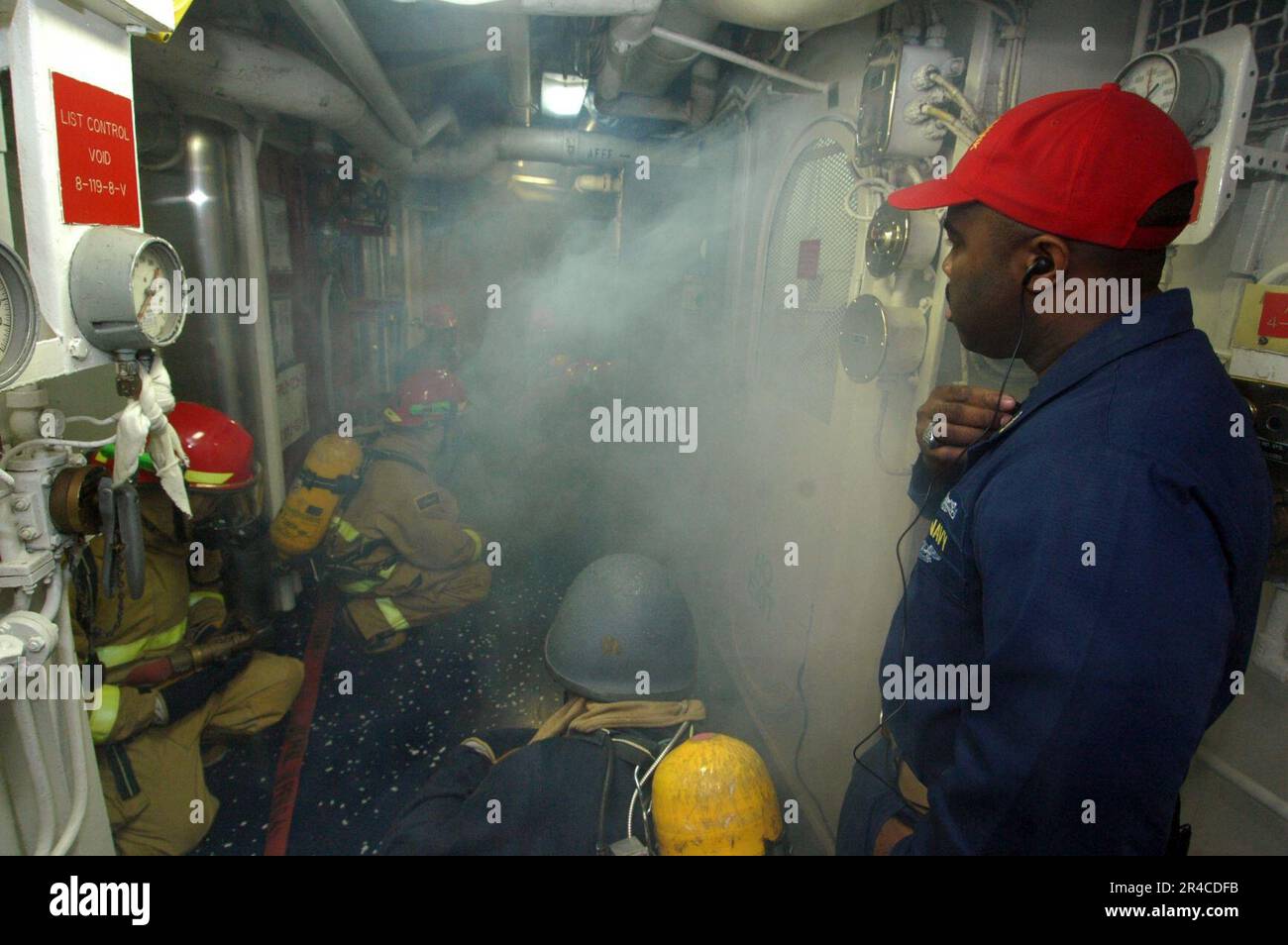 US Navy Senior Chief Damage Controlman supervises USS Kitty Hawk's (CV ...