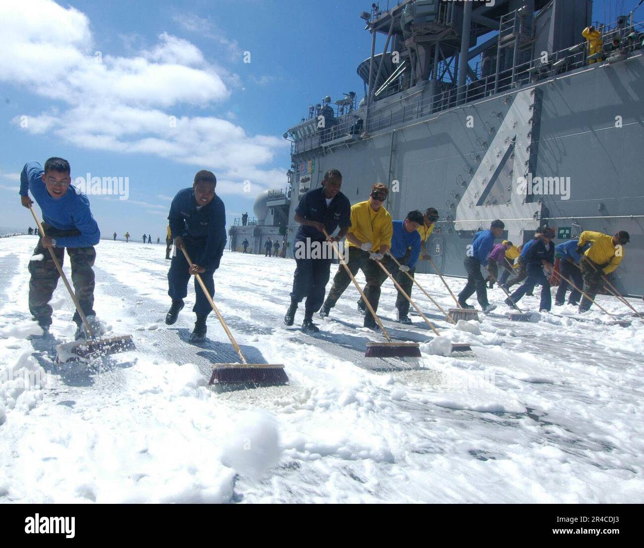 US Navy Sailors conduct a scrubbing exercise on the flight deck aboard ...