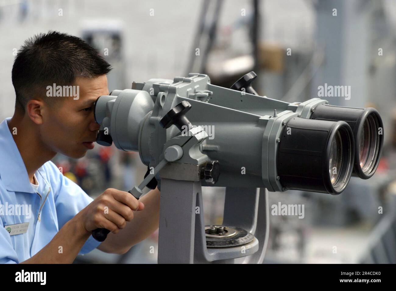 US Navy Culinary Specialist Seaman observes a vertical replenishment ...