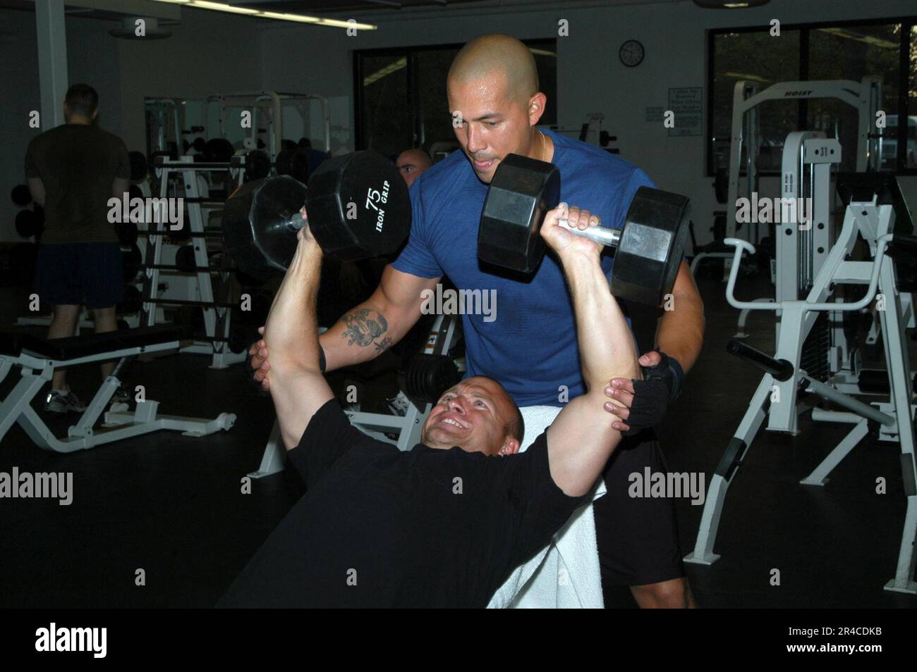 US Navy Damage Controlman 2nd Class lifts weights while Machinist's ...