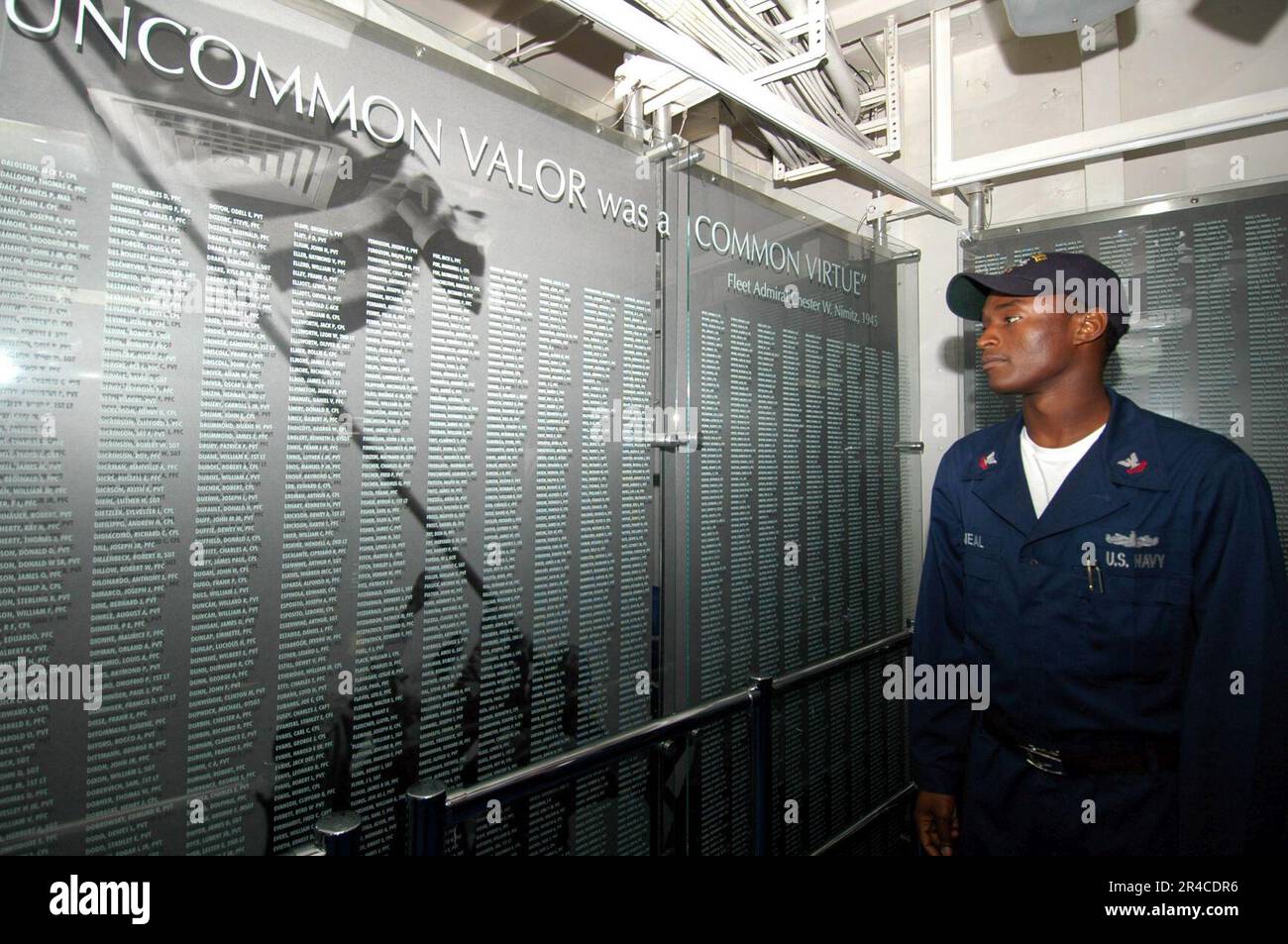 US Navy Quartermaster 2nd Class pauses to read the names of those lost ...