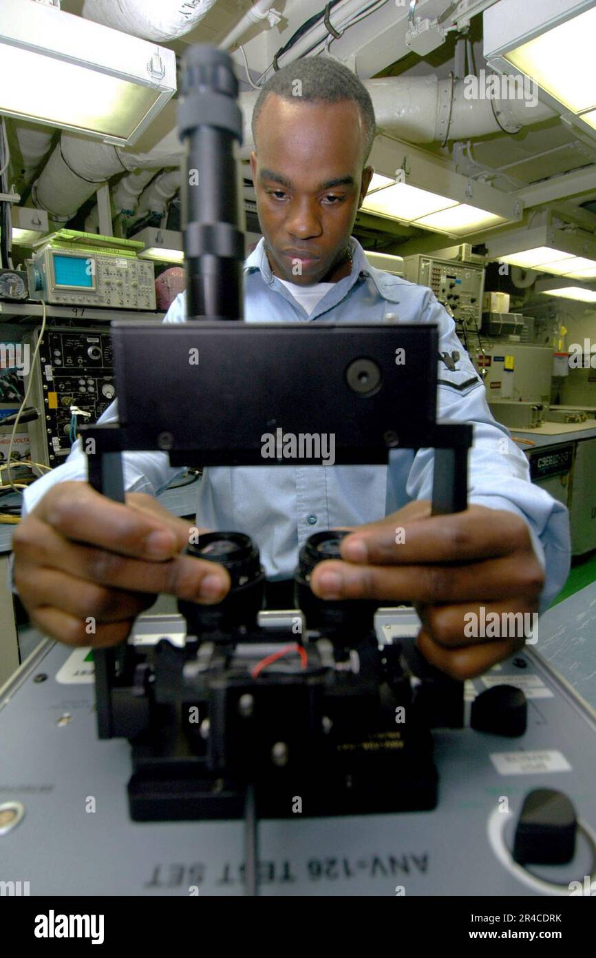 US Navy Aviation Electronics Technician 3rd Class calibrates a pair of ...