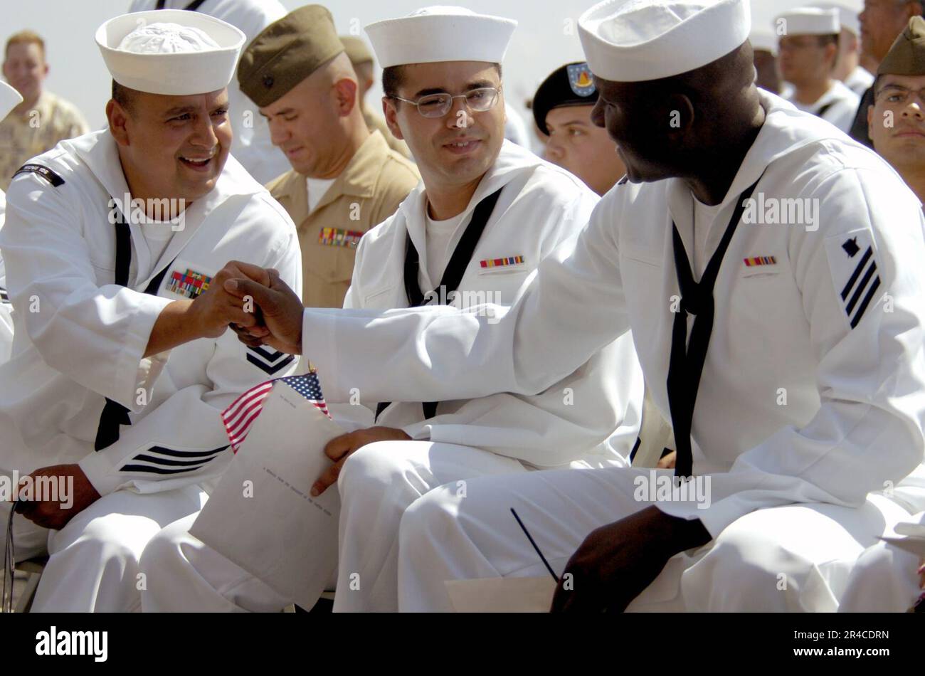 US Navy Sailors congratulate one another following the completion of a ...
