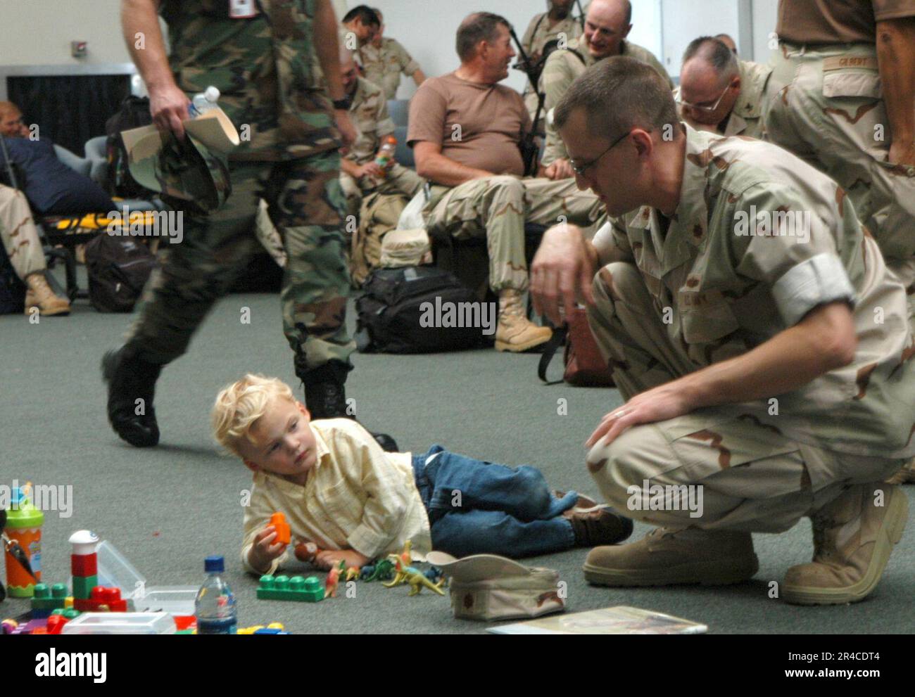 US Navy Lt. Cmdr. plays with his son as his battalion prepares to ...