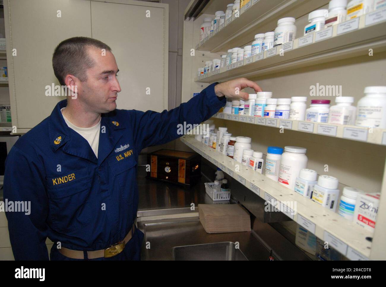 US Navy Hospital Corpsman Chief organizes prescription bottles in the ...
