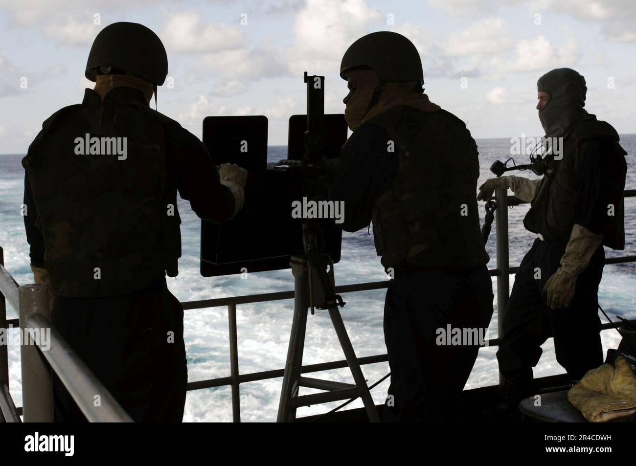 US Navy Weapons department Sailors prepare a .50-caliber machine gun ...