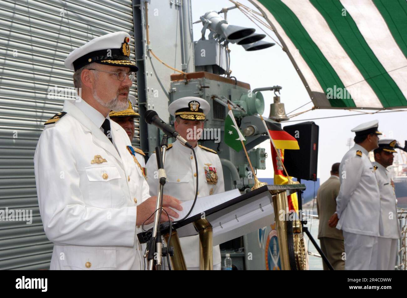 US Navy German Rear Adm. left, speaks during a change of command ceremony, aboard Pakistani ...