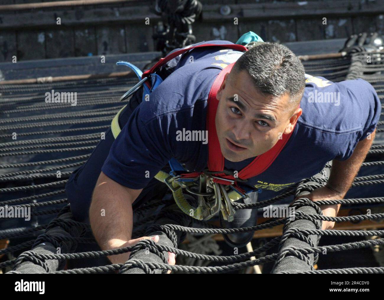 US Navy A Chief Petty Officer (CPO) selectee climbs the mainmast shroud ...