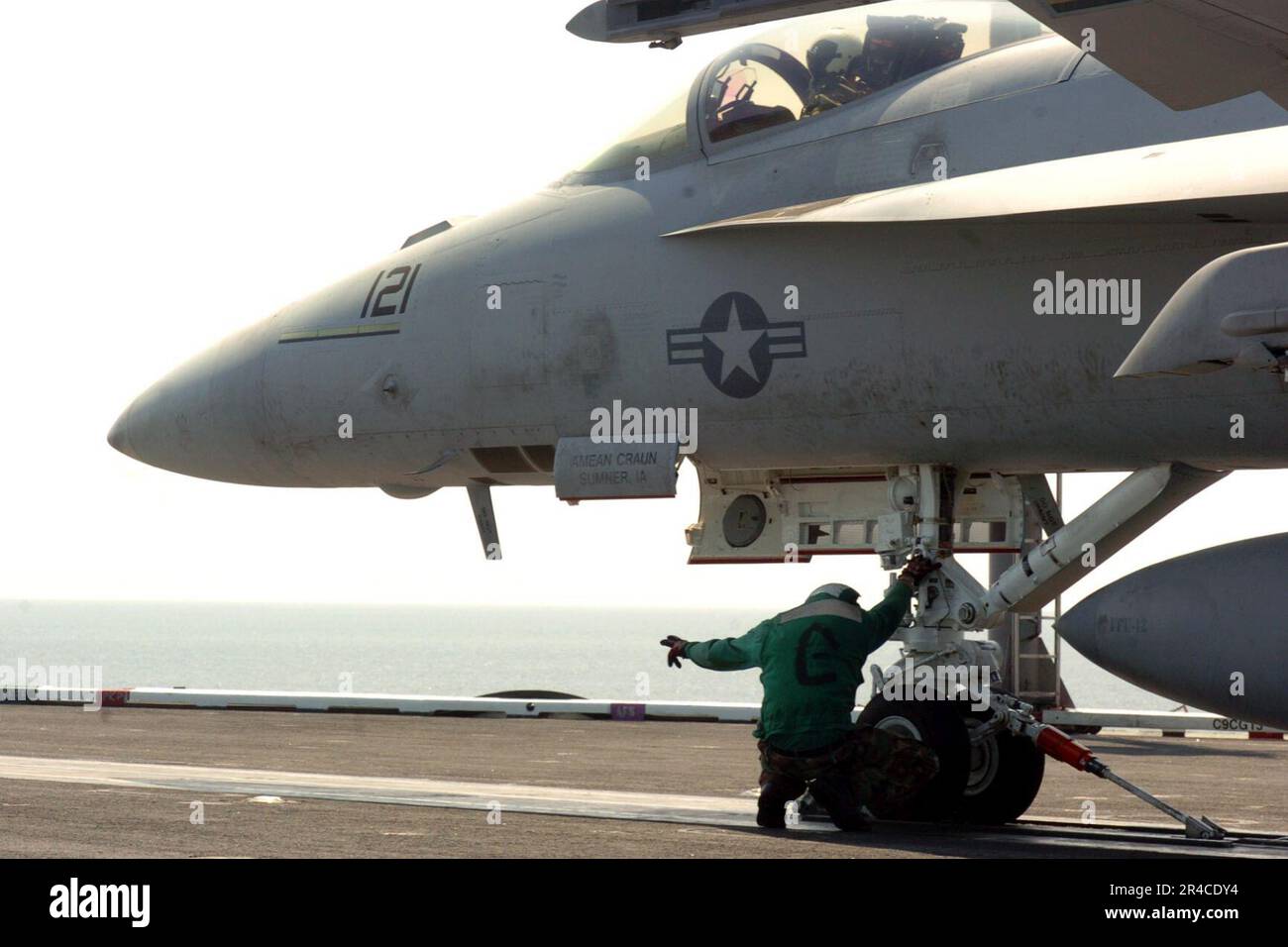 US Navy A flight deck crew member signals to advance the shuttle for ...