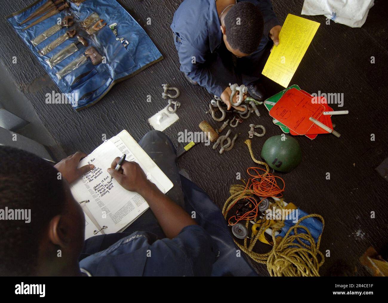 US Navy Seamen take inventory of tools and equipment used by Deck ...