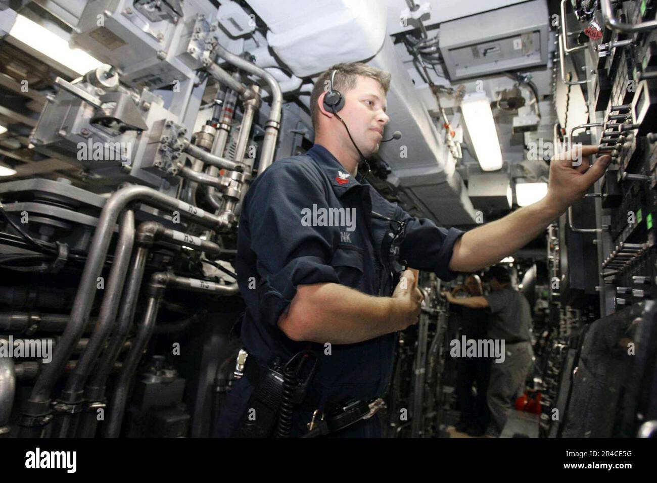 US Navy Petty Officer 1st class assists in a shipboard test evolution ...