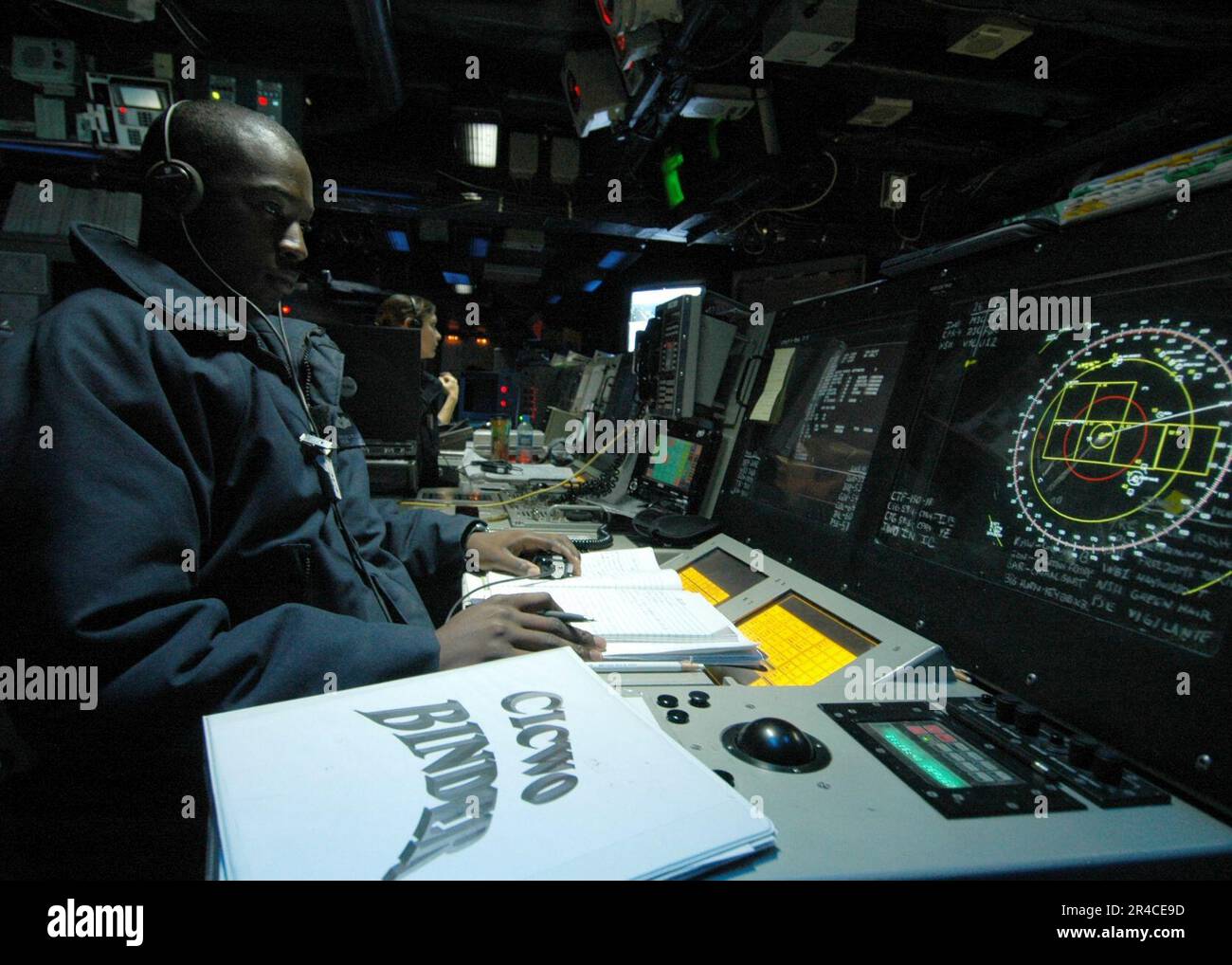 US Navy Operations Specialist 1st Class stands Combat Information ...