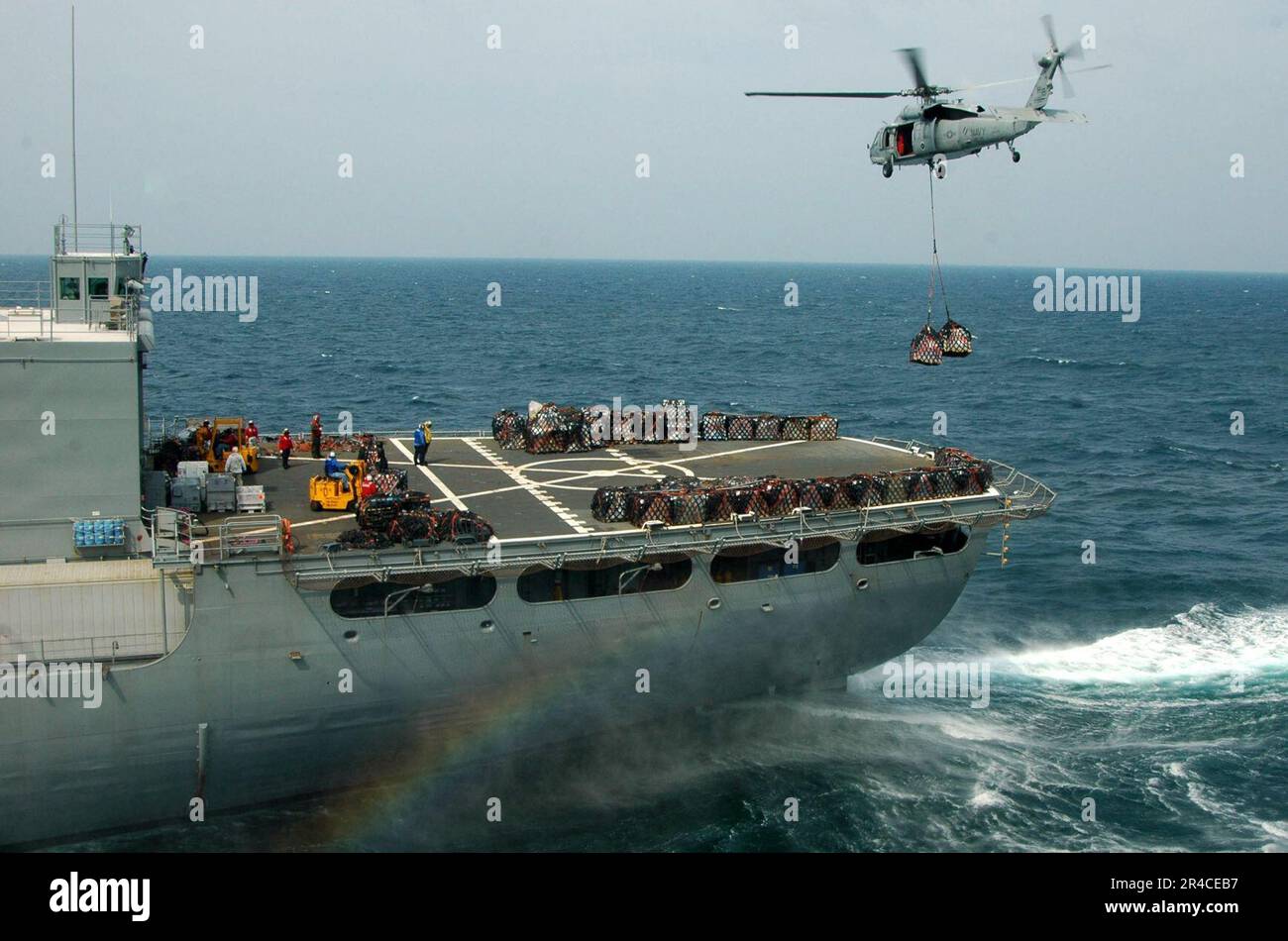 US Navy An MH-60S Seahawk from Helicopter Sea Combat Support Squadron (HCS-25) transports cargo ...