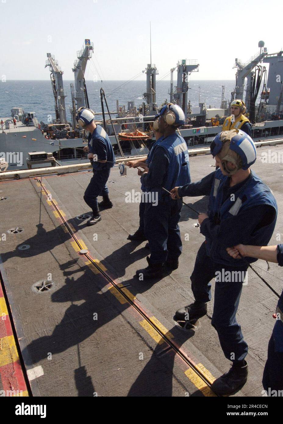 US Navy Crew members aboard the nuclear-powered aircraft carrier USS ...