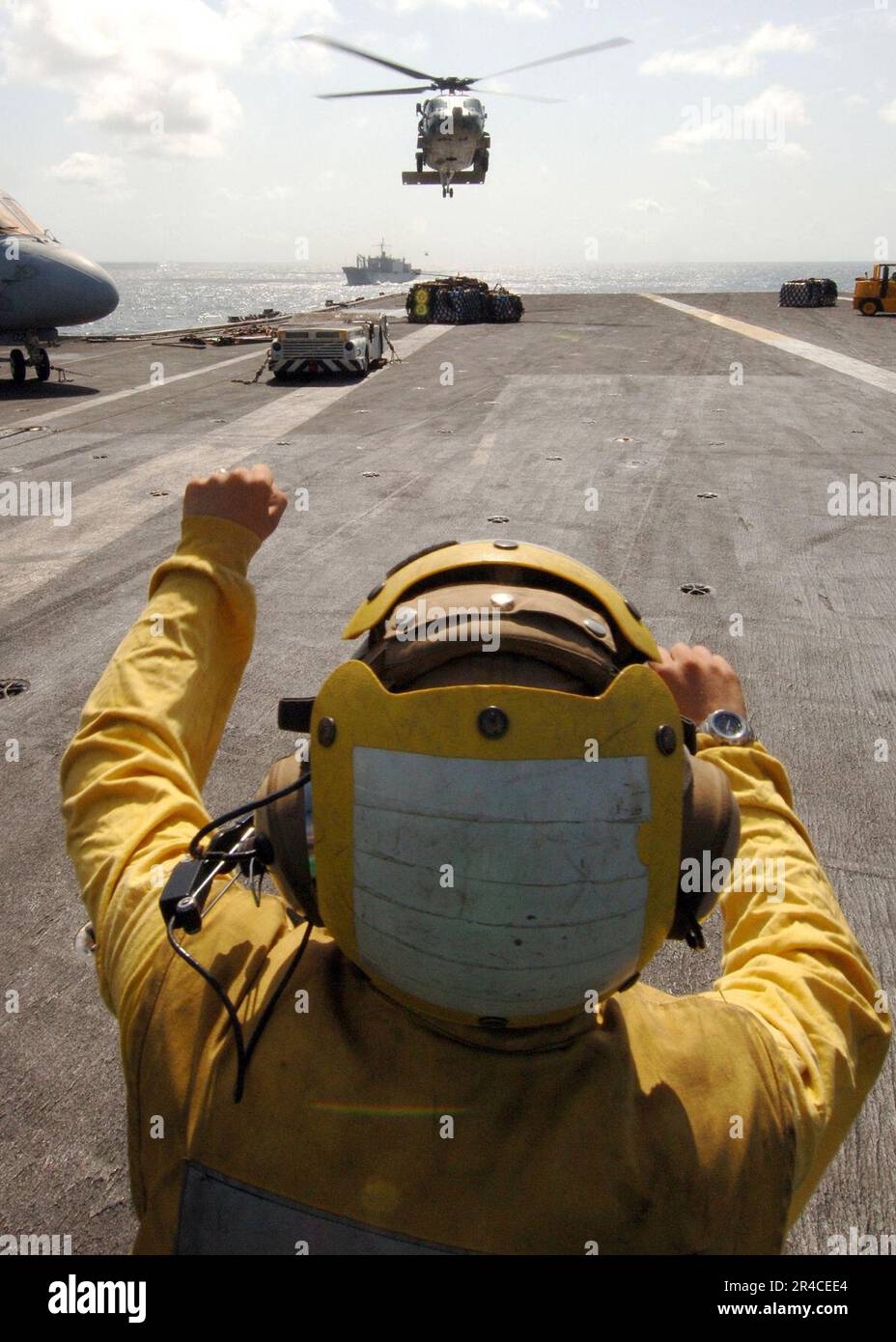 US Navy Aviation Boatswain's Mate 3rd Class signals a Seahawk ...