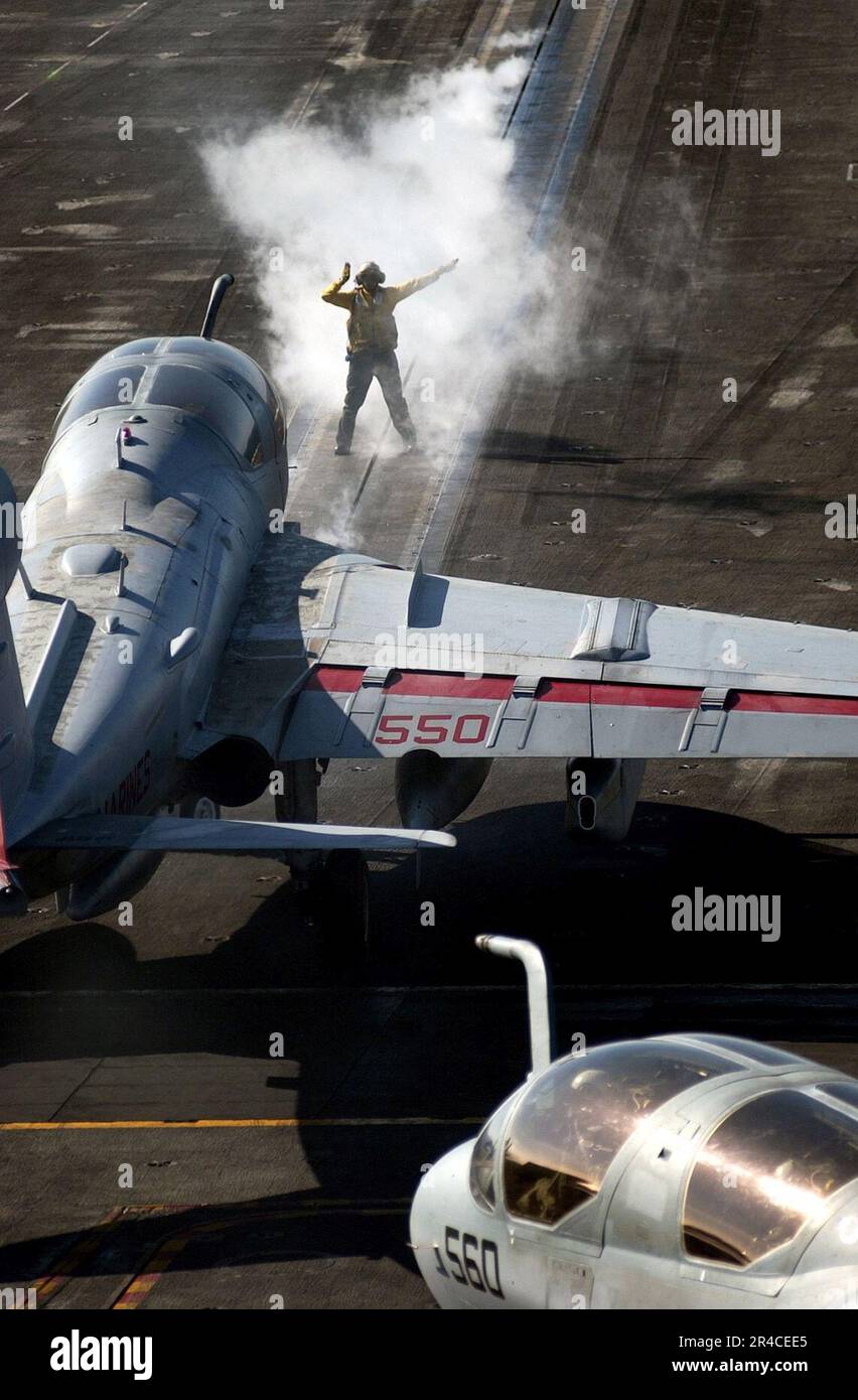 US Navy An aircraft handler directs a U.S. Marine Corps EA-6B Prowler ...