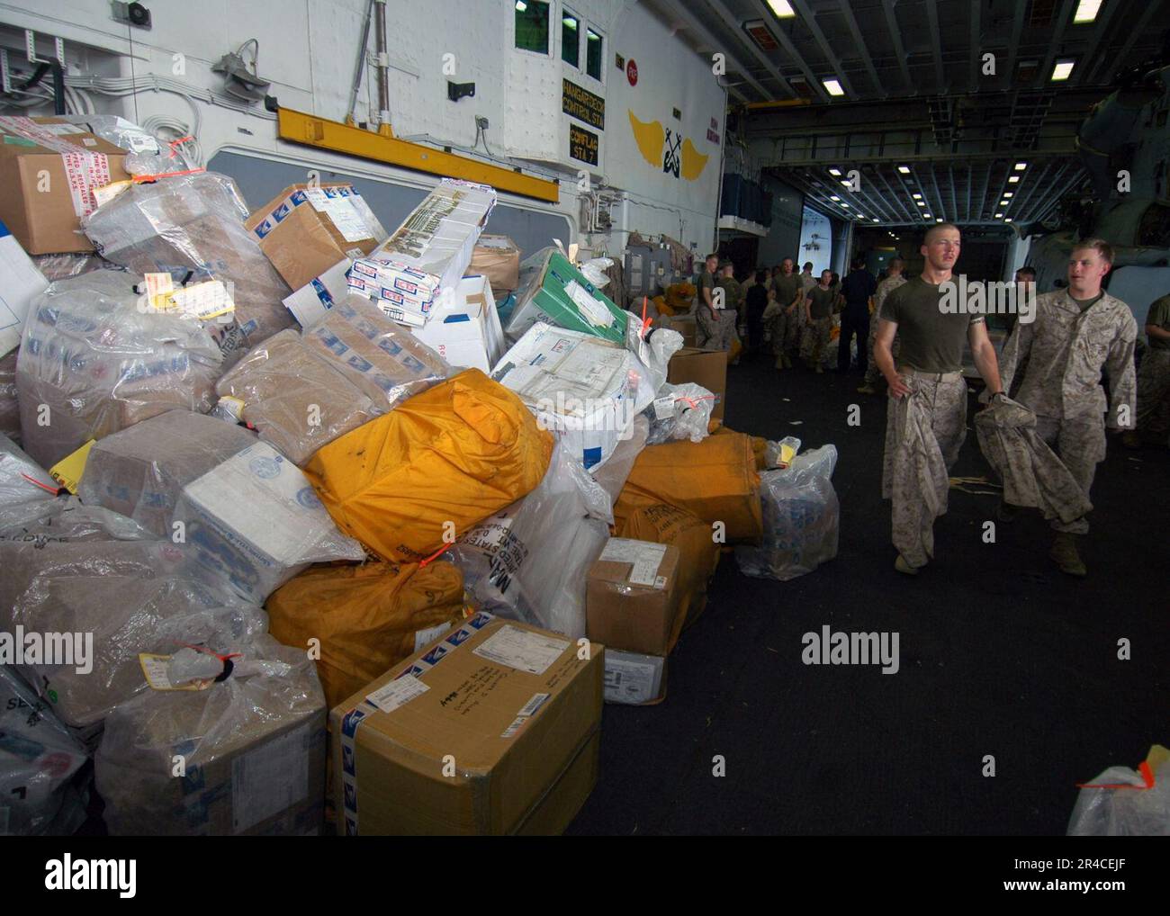 US Navy Piles of mail sit in the hangar bay after a vertical ...