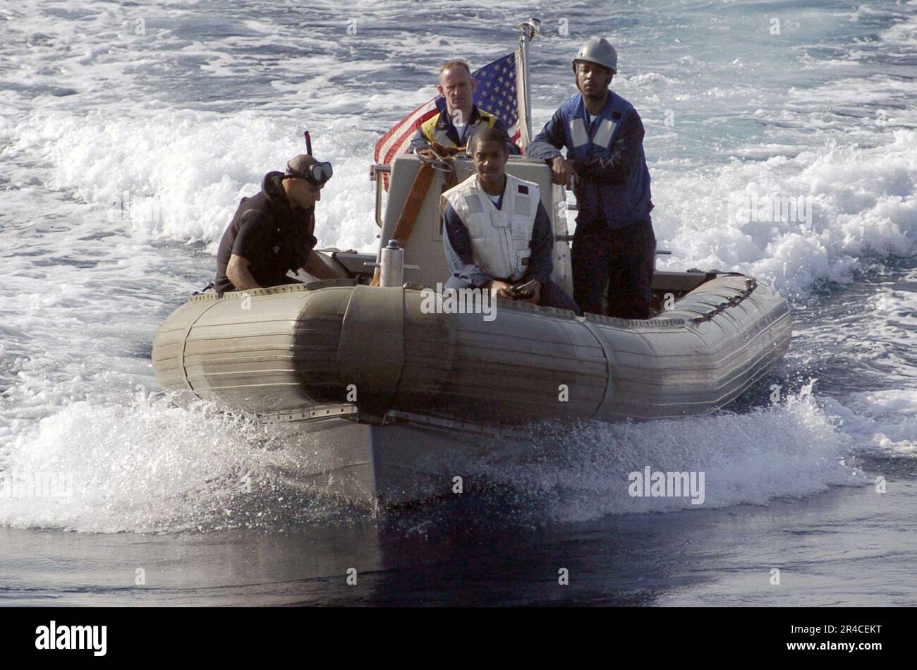 US Navy A Rigid Hull Inflatable Boat (RHIB) returns to the USS Kitty ...