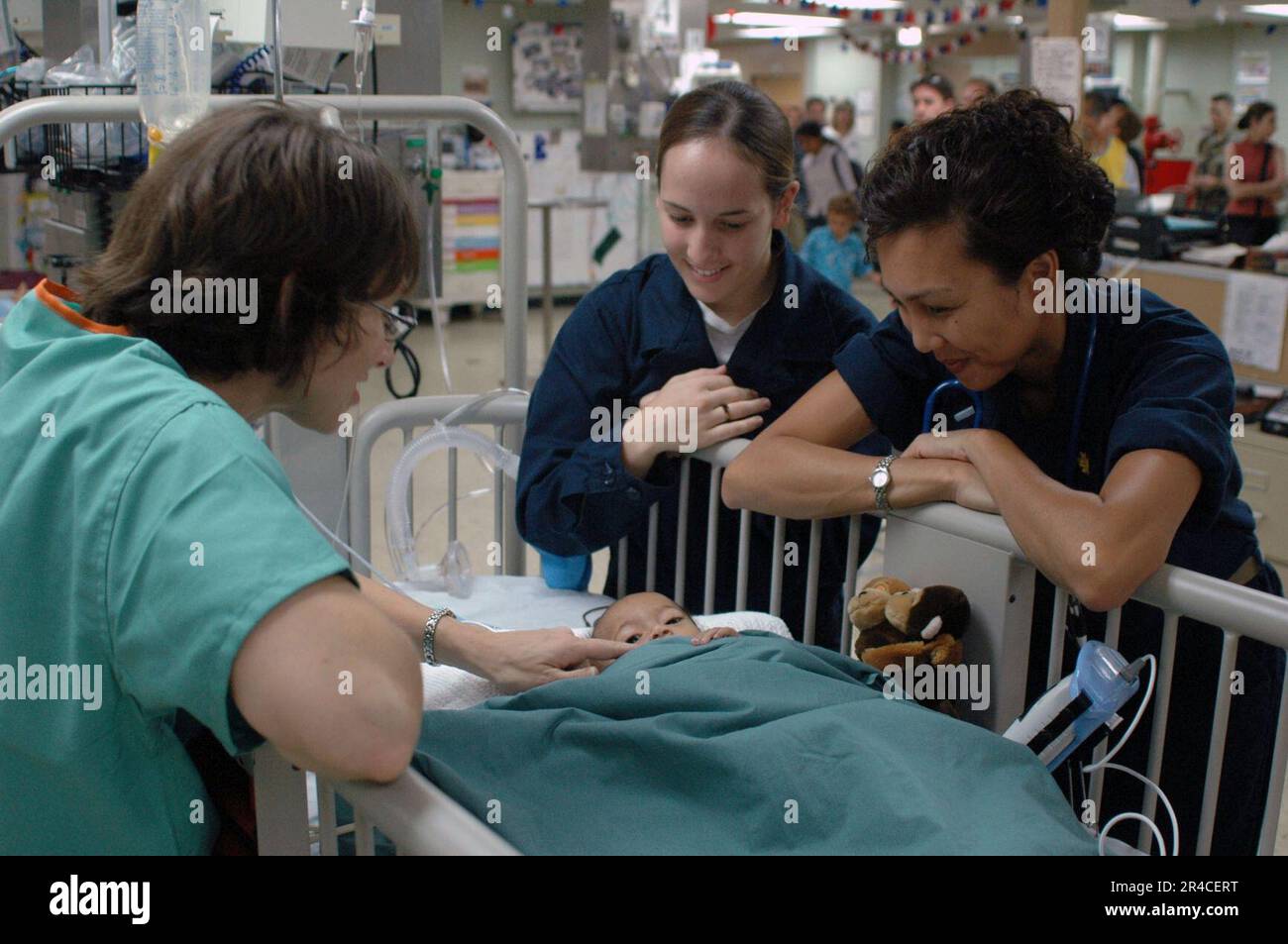 US Navy Navy Lt. left, Hospitalman center, and Lt. jg. comfort a small ...