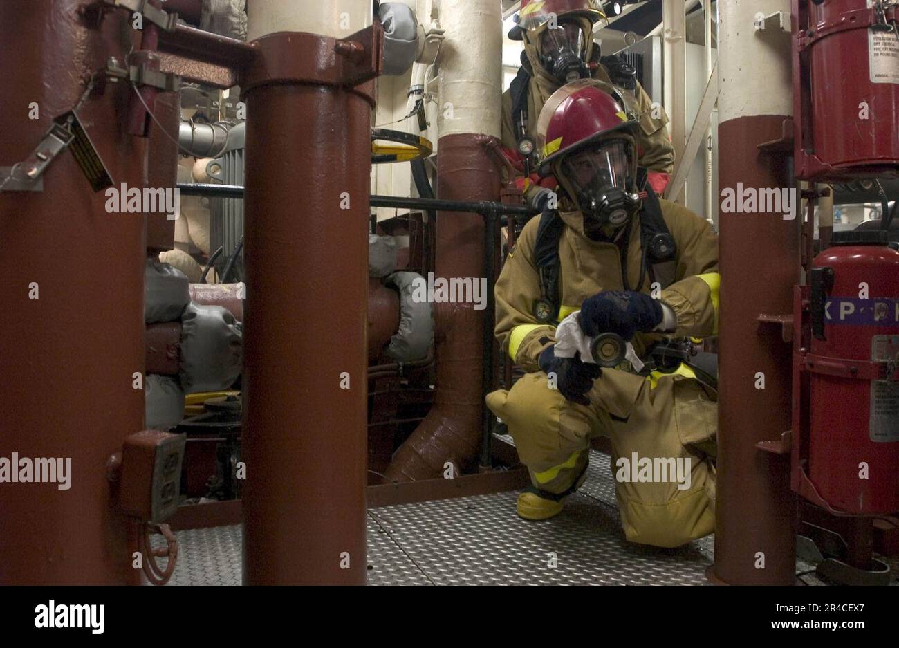 US Navy Gas Turbine Systems Technician Fireman watches for a reflash ...