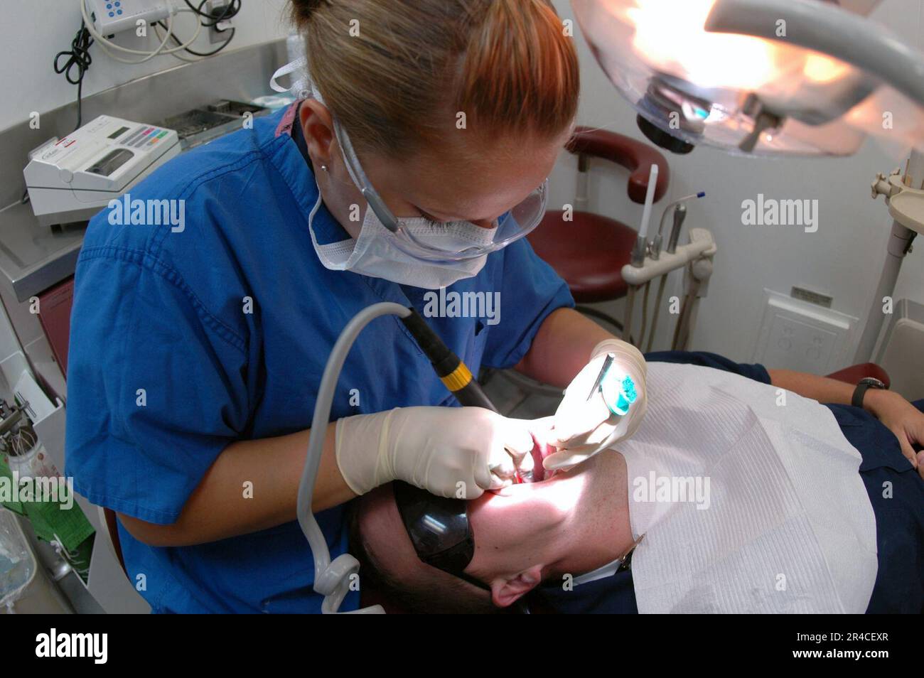 US Navy Hospital Corpsman Seaman Apprentice performs a dental polishing ...