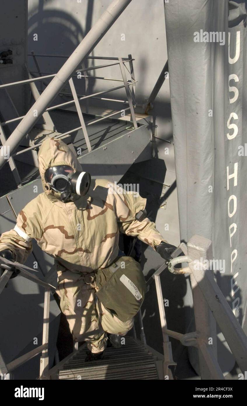 US Navy Hull Technician 3rd Class wears an Advanced Chemical Protective ...