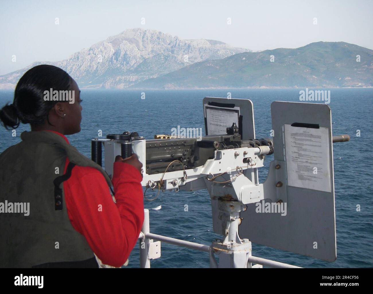 US Navy Aviation Ordnanceman Apprentice stands watch on a .50 caliber ...