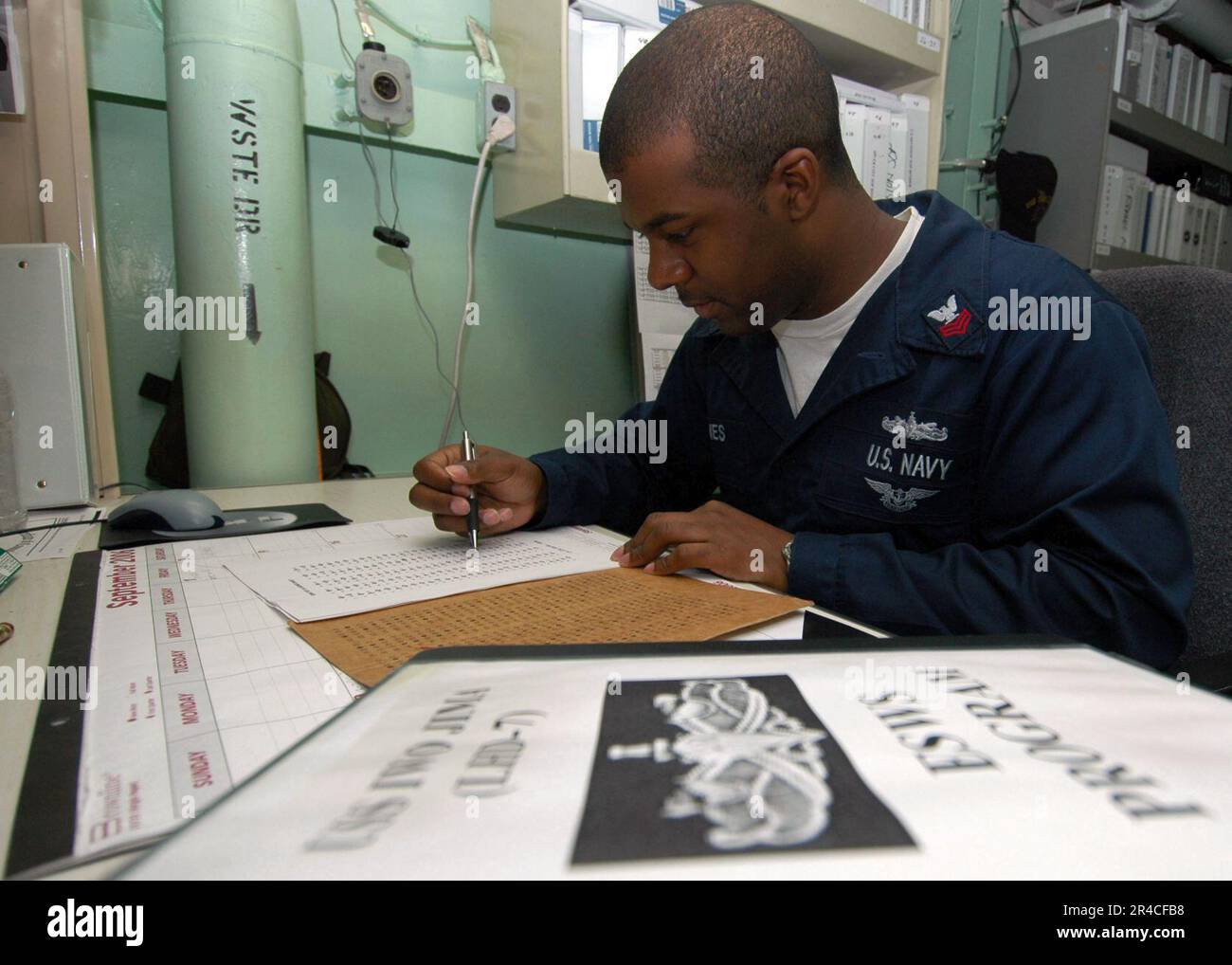 US Navy Information Systems Technician grades an Enlisted Surface ...