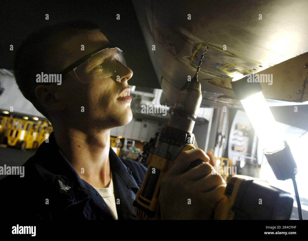 US Navy Aviation Structural Mechanic 3rd Class performs maintenance on ...