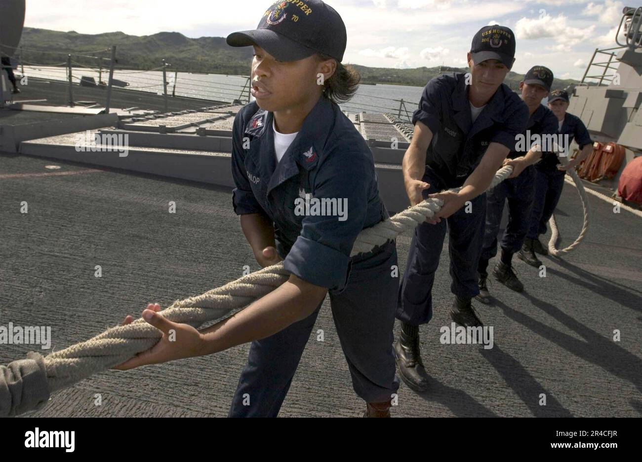 US Navy Information Systems Technician 2nd Class heaves in a mooring ...