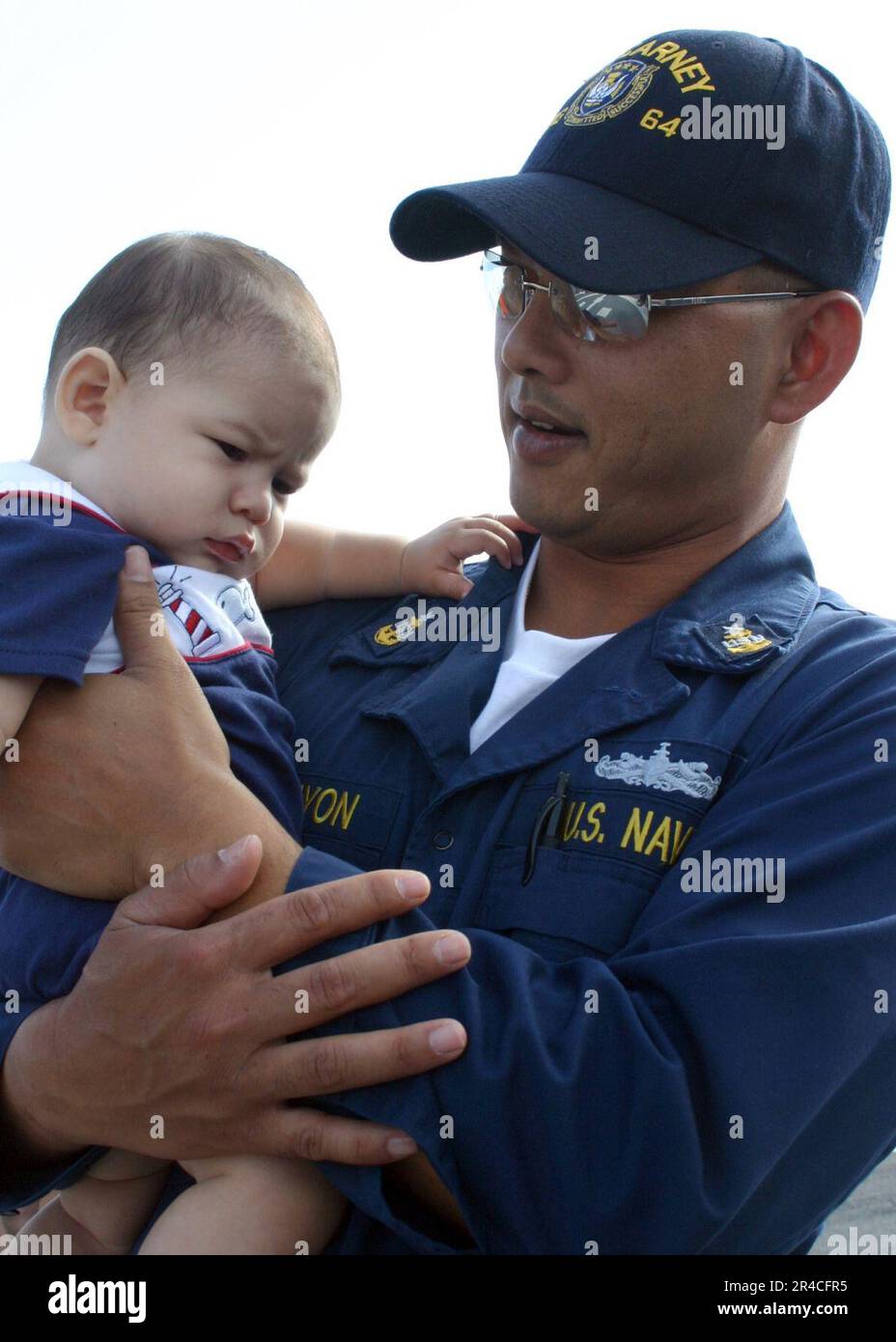 US Navy Senior Chief Hospital Corpsman holds his six-month old son upon ...