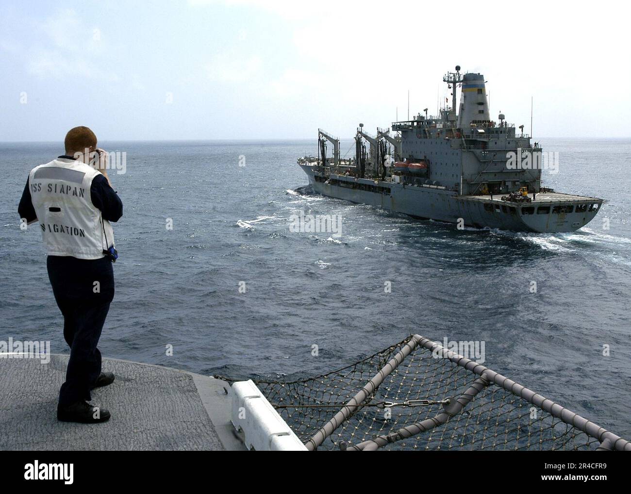 US Navy Quartermaster 2nd Class checks the distance between the U.S. Military Sealift Command ...