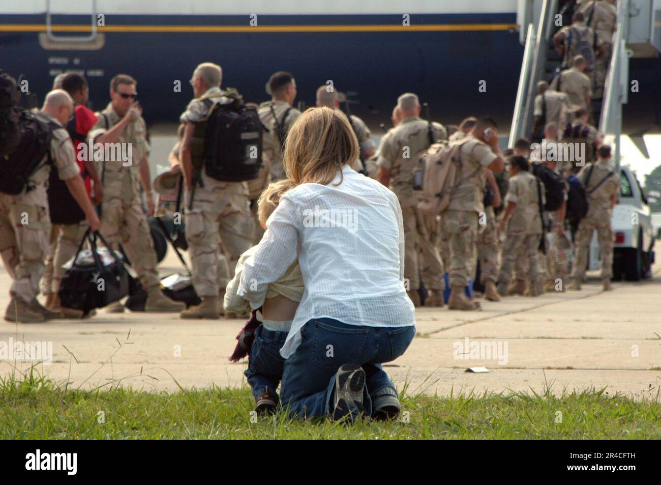 US Navy A mother holds on to her son, as they watch her husband, Lt ...