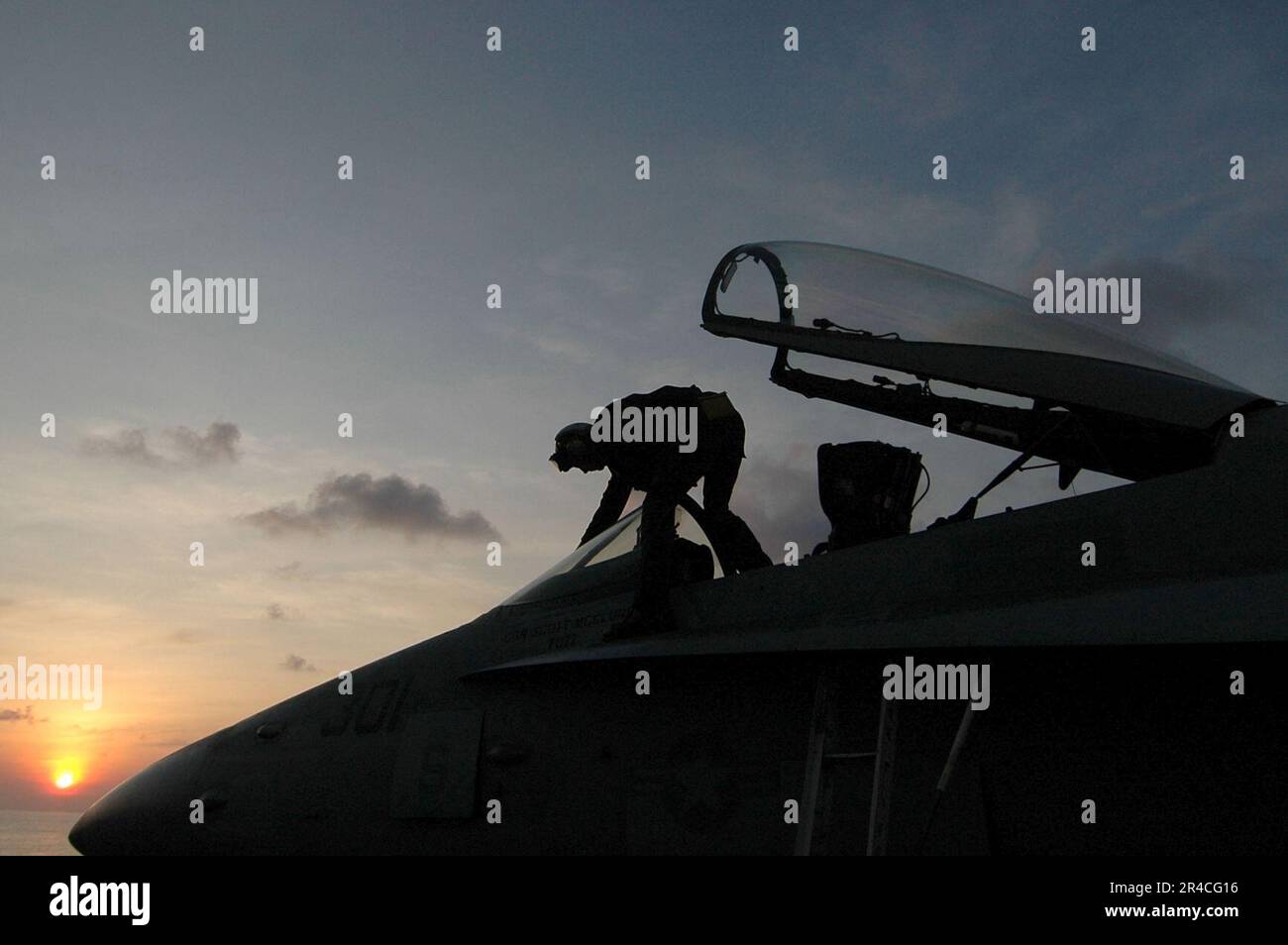 US Navy Airman cleans the canopy of an F-A-18C Hornet assigned to ...
