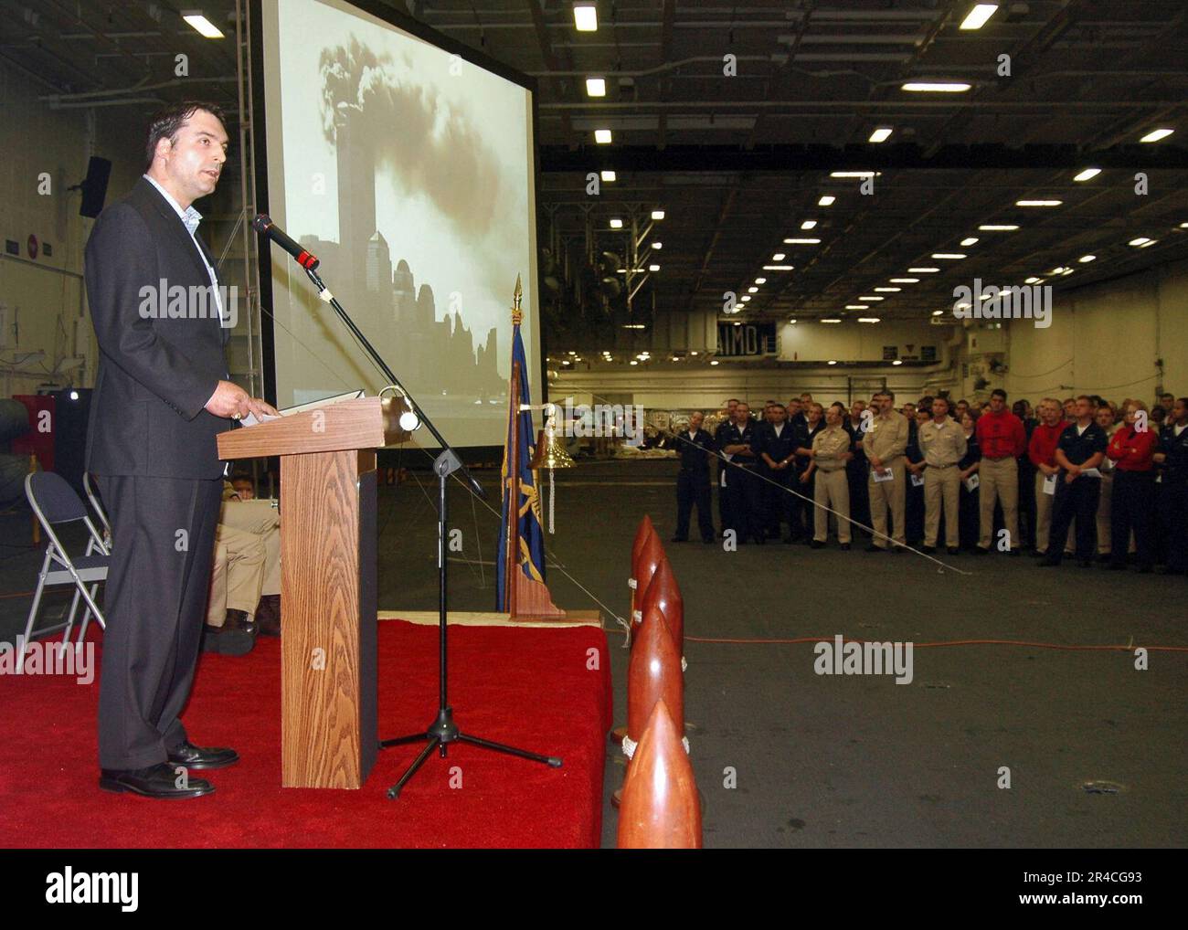 US Navy Lt. (Ret.), speaks to the crew aboard the Nimitz-class aircraft ...