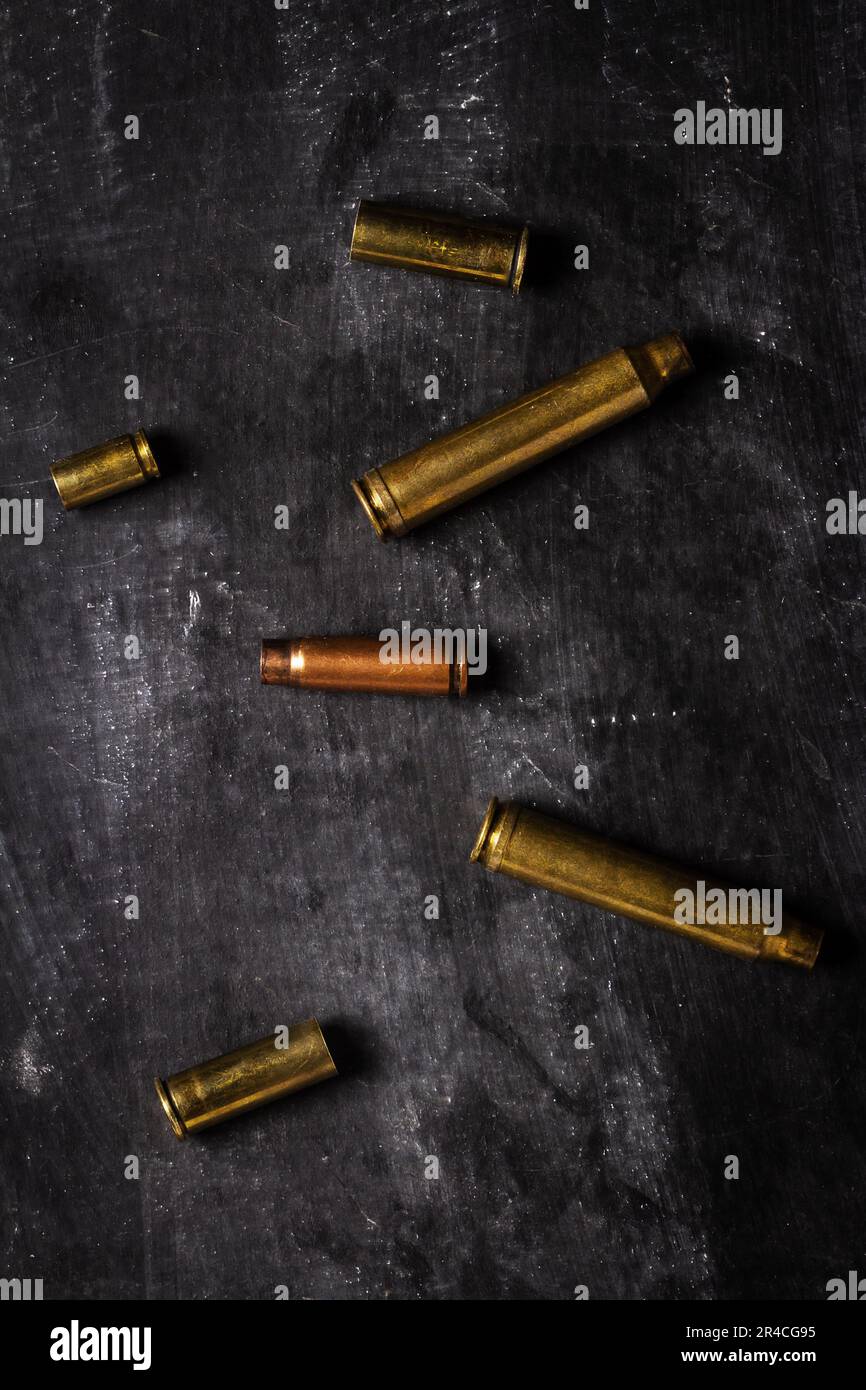 Empty bullet cartridges lying on the black background Stock Photo - Alamy