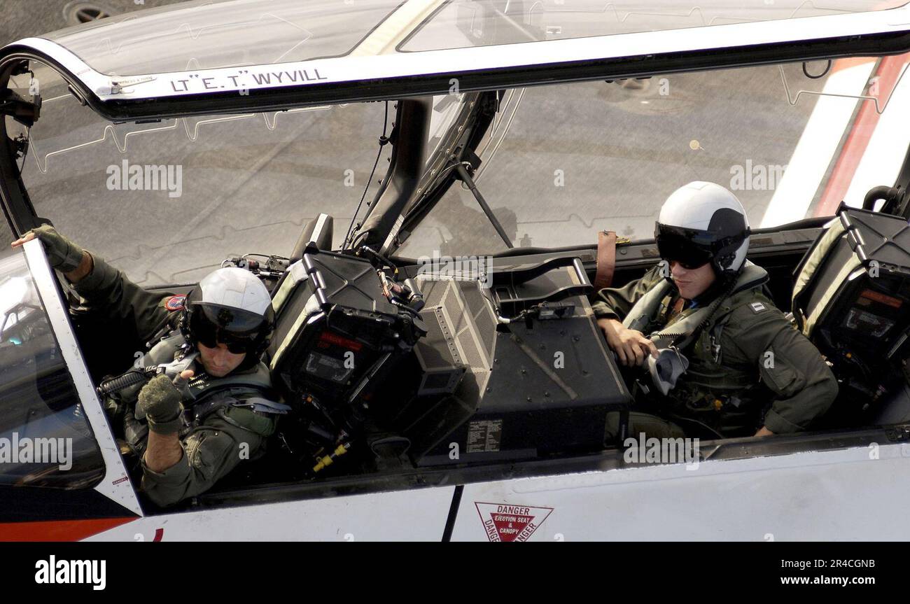 US Navy An instructor pilot is joined by his student in the cockpit of ...