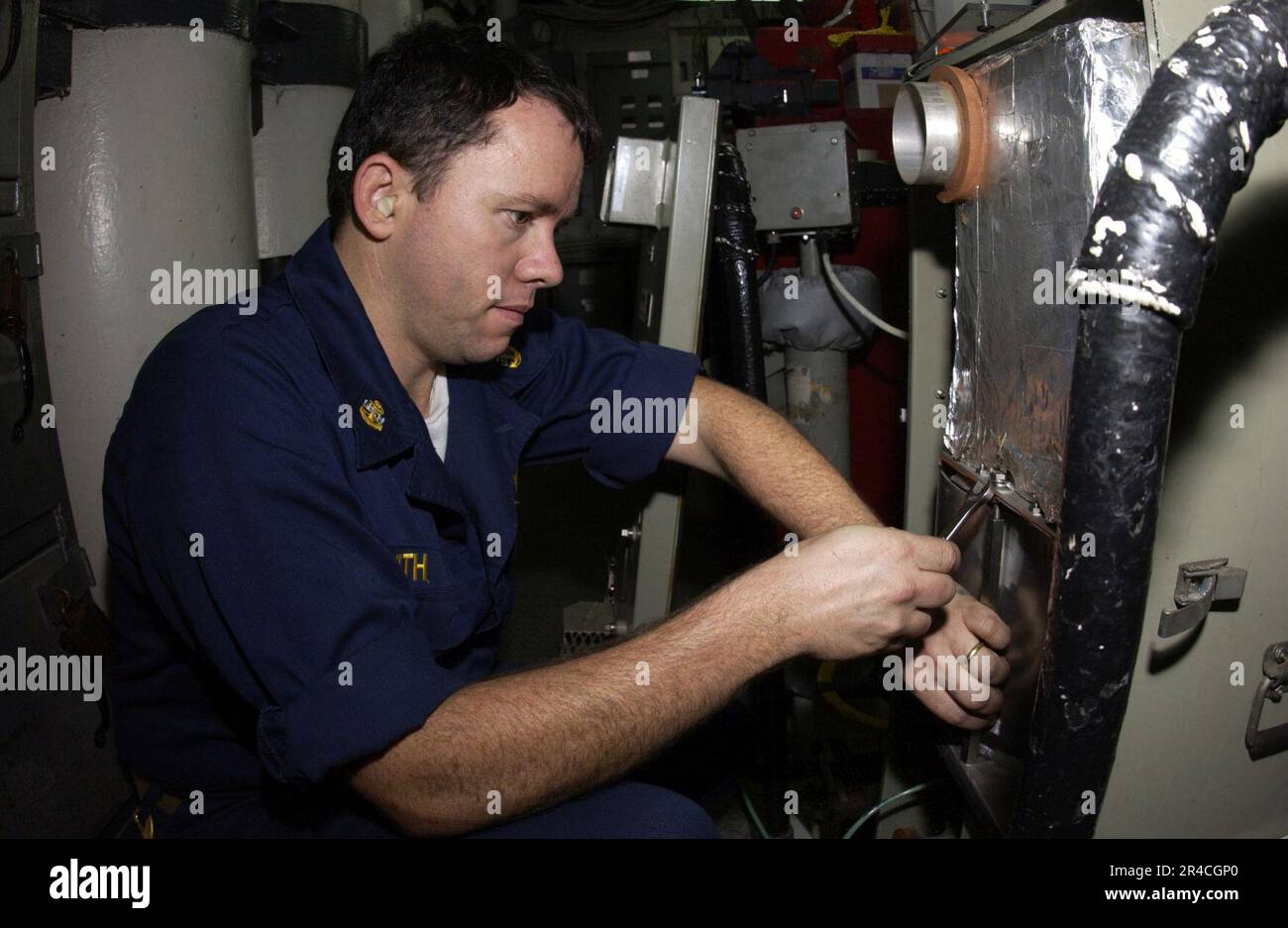 US Navy Chief Gas Turbine Systems Technician Electrical changes out a ...