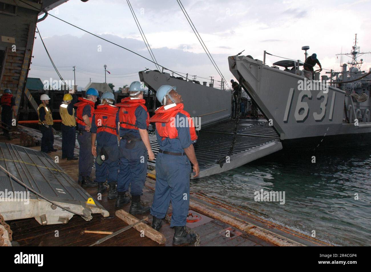 US Navy Boatswain's mates aboard USS Essex (LHD 2) line up to secure an ...