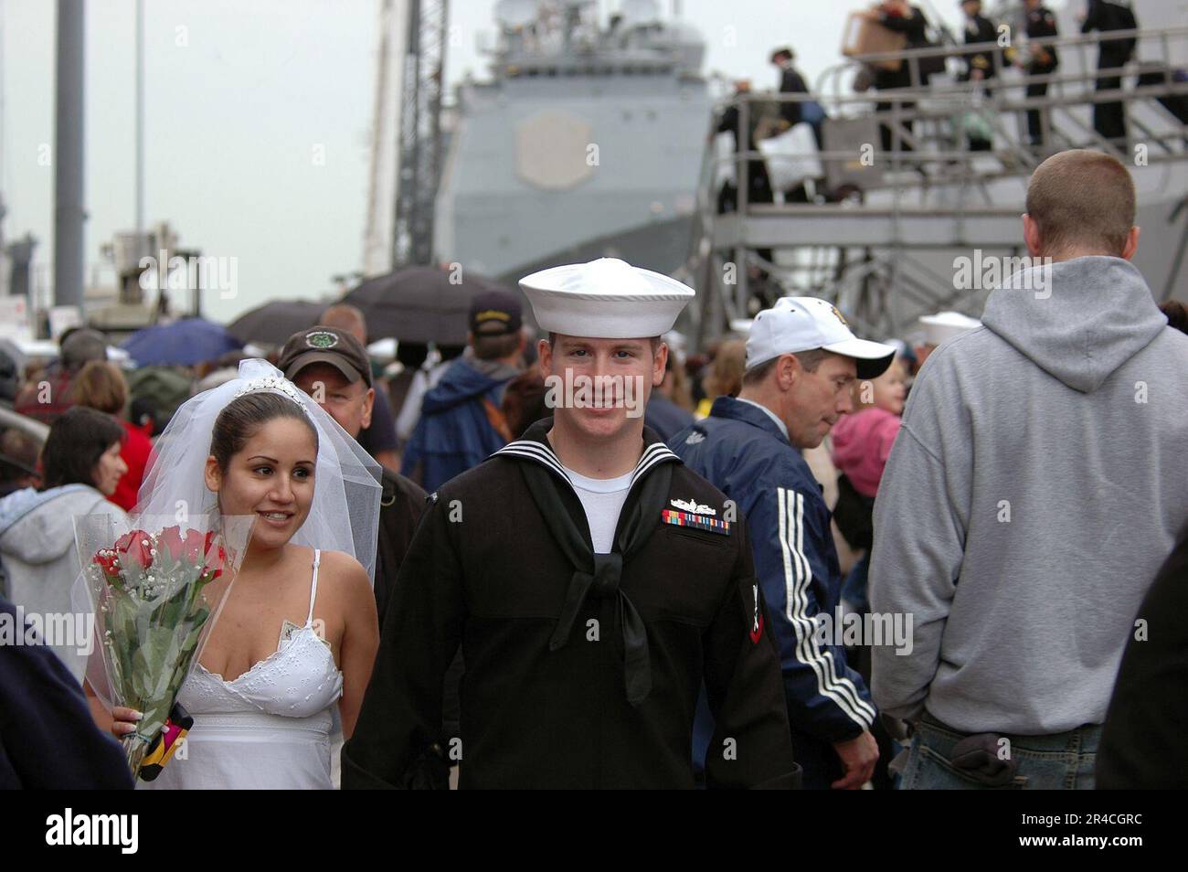 US Navy Gunner's Mate 3rd Class and his fiancée depart the pier to get ...